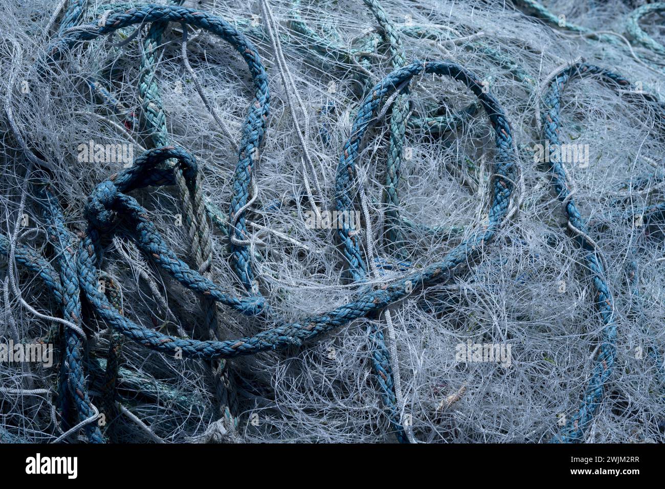 Bunch of abandoned fishing nets and ropes lying around on pier Stock ...