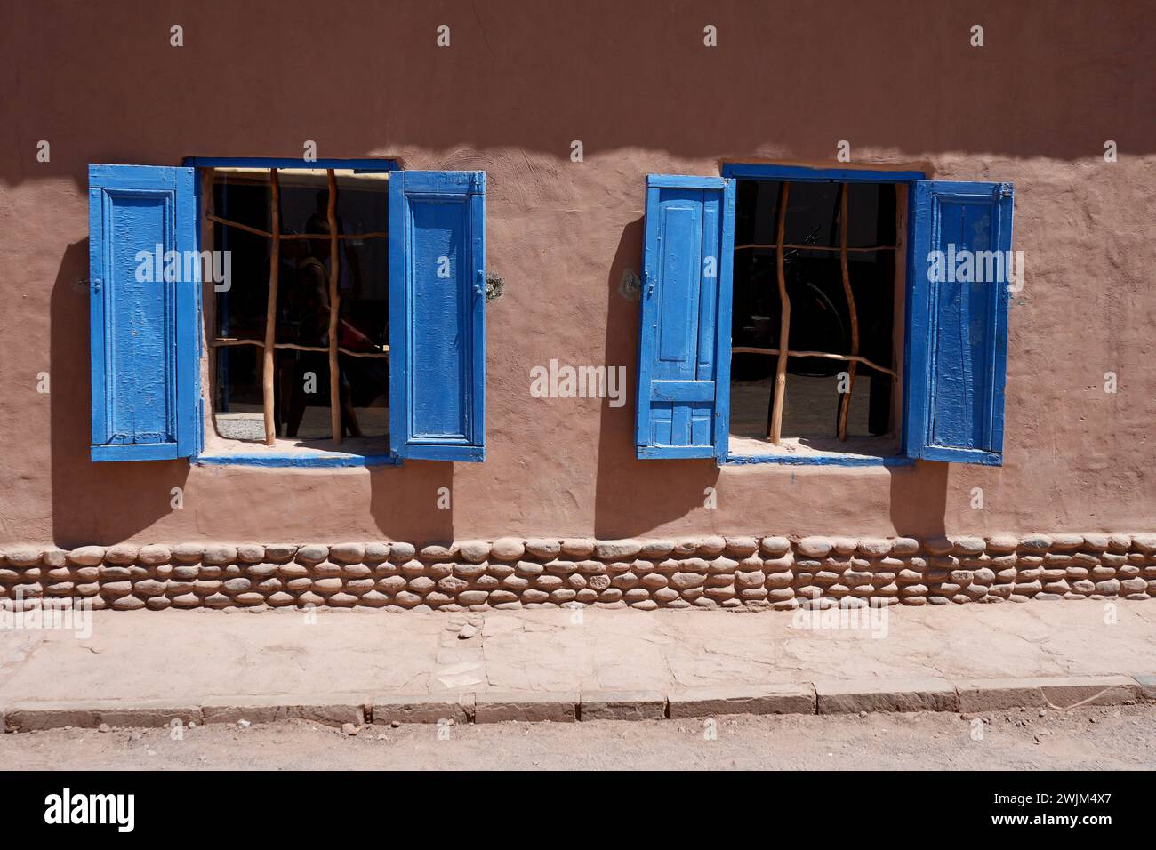 Rustic windows with blue shutters on a clay wall.Chile Stock Photo - Alamy