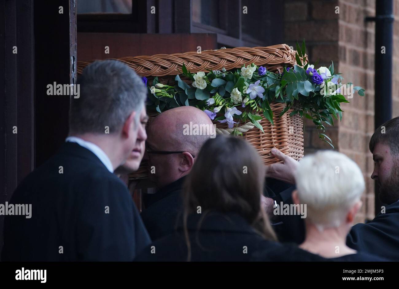 Pall bearers carry the casket into the Requiem Mass for former Rochdale ...