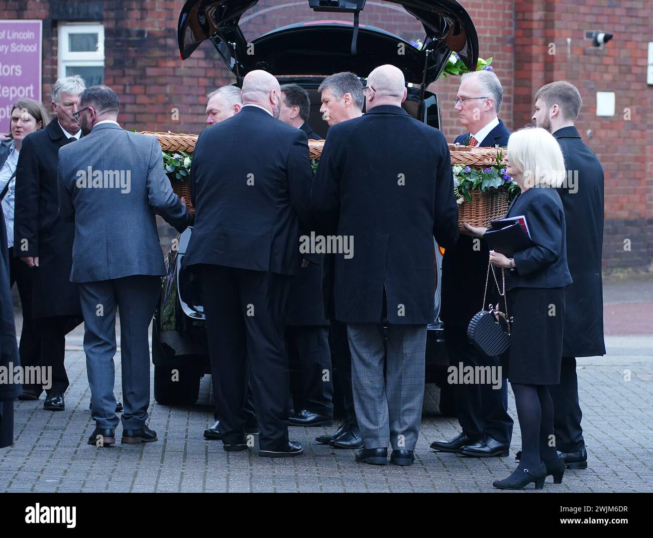 Pall bearers carry the casket into the Requiem Mass for former Rochdale ...