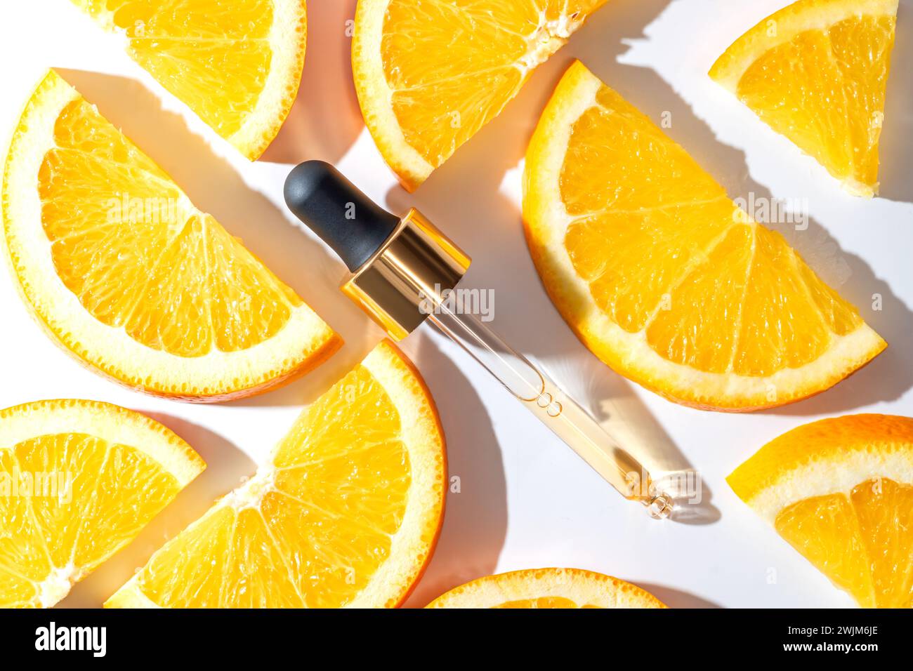 close up of pipette with pouring liquid serum with vitamin C and ...