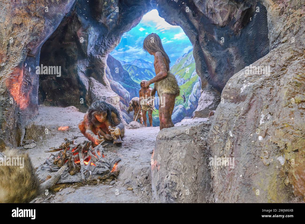 A tribe starts a fire. Detail of a paleolithic, stone age, cave man ...