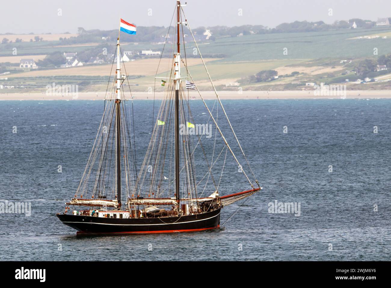 Old two-masted rig, sails down in Douarnenez Bay, Finistère, Brittany ...
