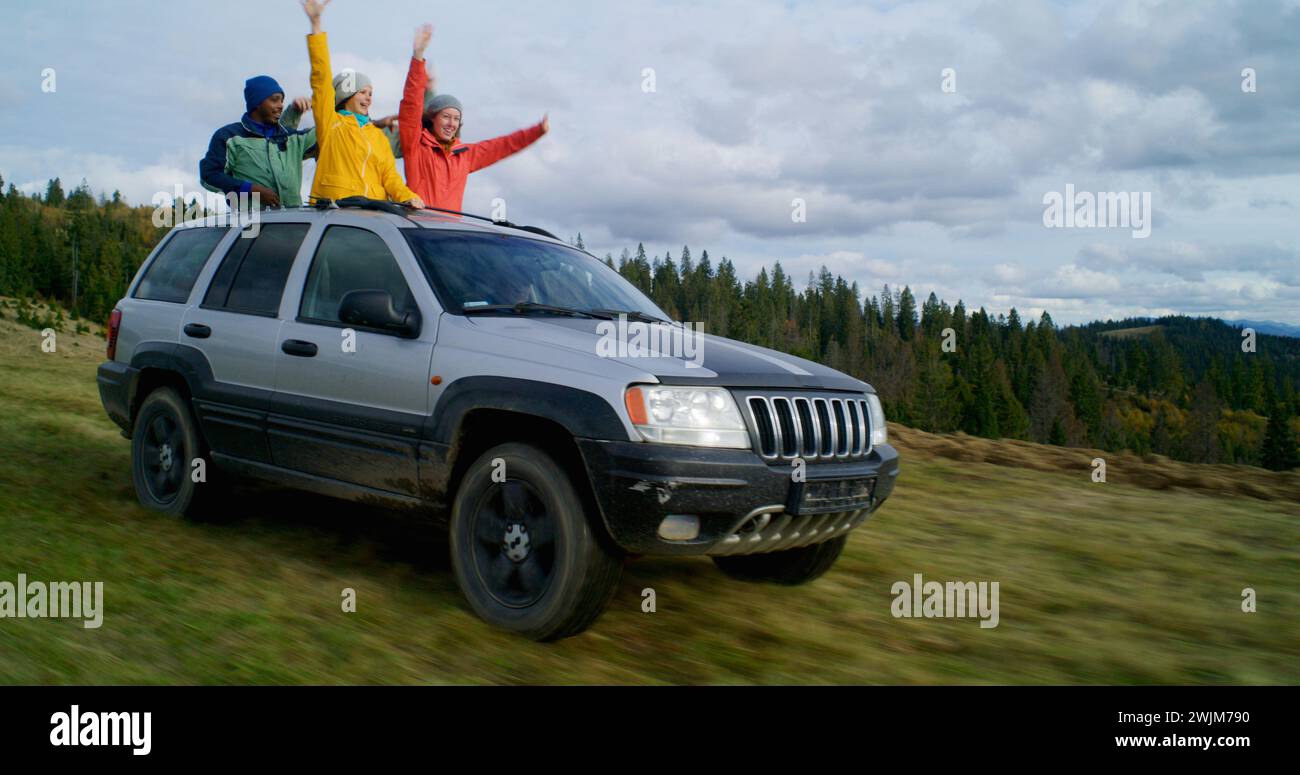 Group of multiethnic tourists together ride on vacation in mountains ...