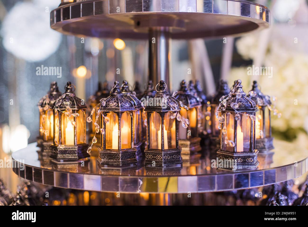 Multiple candles illuminate a table at night Stock Photo - Alamy