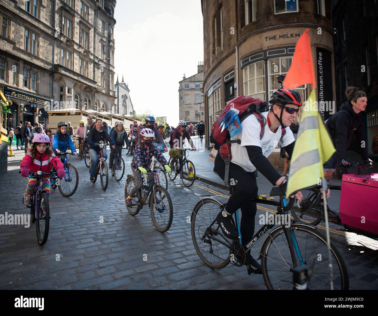 Hundreds of cyclists and people with bikes cycle through the streets of ...