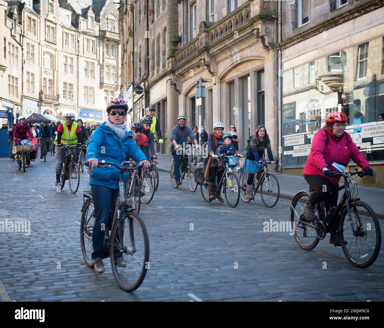 Hundreds of cyclists and people with bikes cycle through the streets of ...