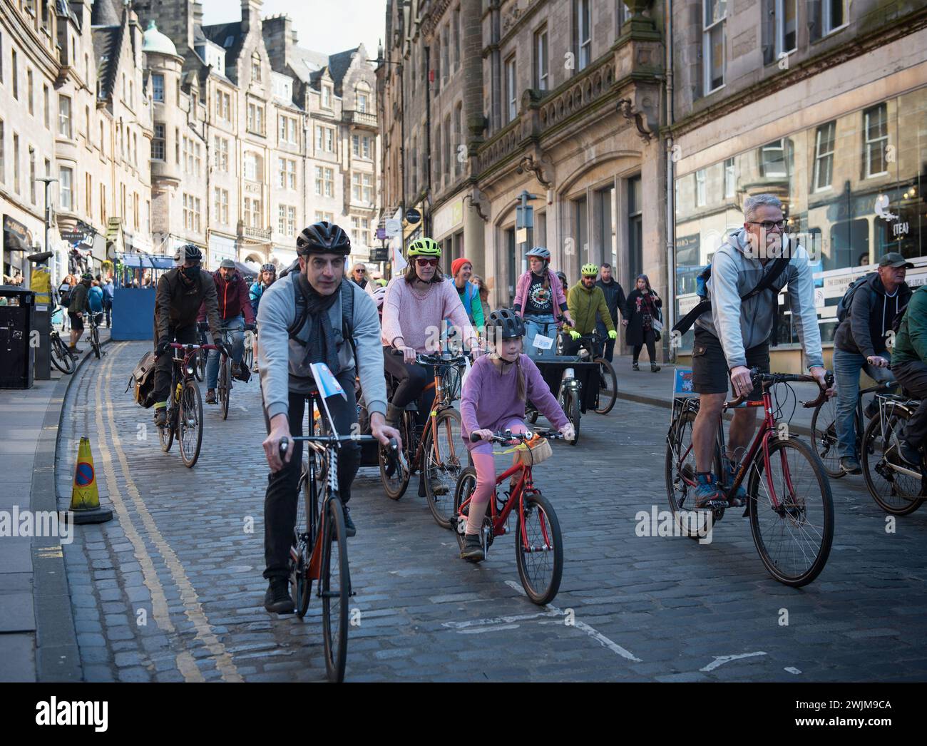 Hundreds of cyclists and people with bikes cycle through the streets of ...