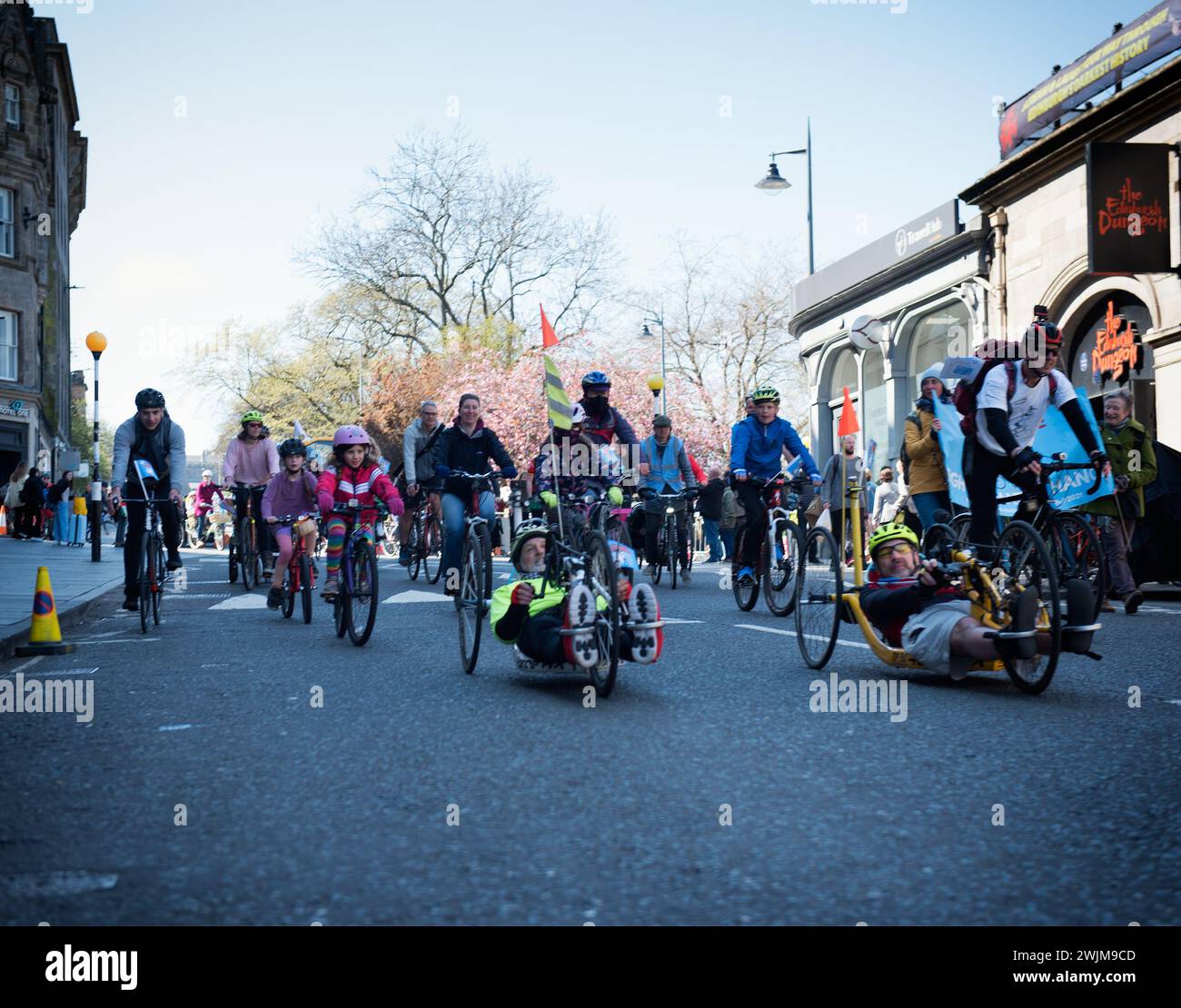 Hundreds of cyclists and people with bikes cycle through the streets of ...