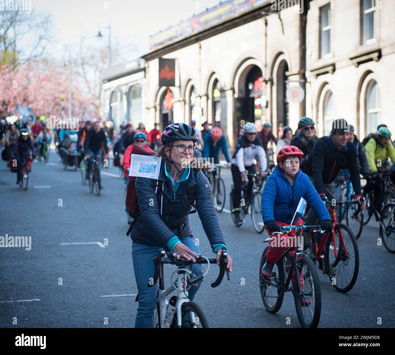 Hundreds of cyclists and people with bikes cycle through the streets of ...
