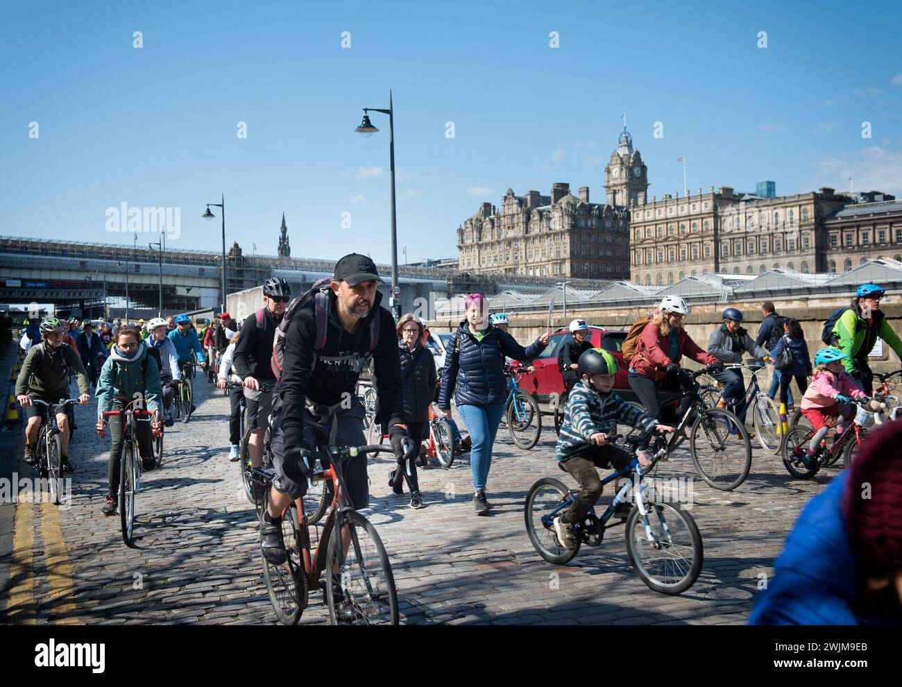 Hundreds of cyclists and people with bikes cycle through the streets of ...