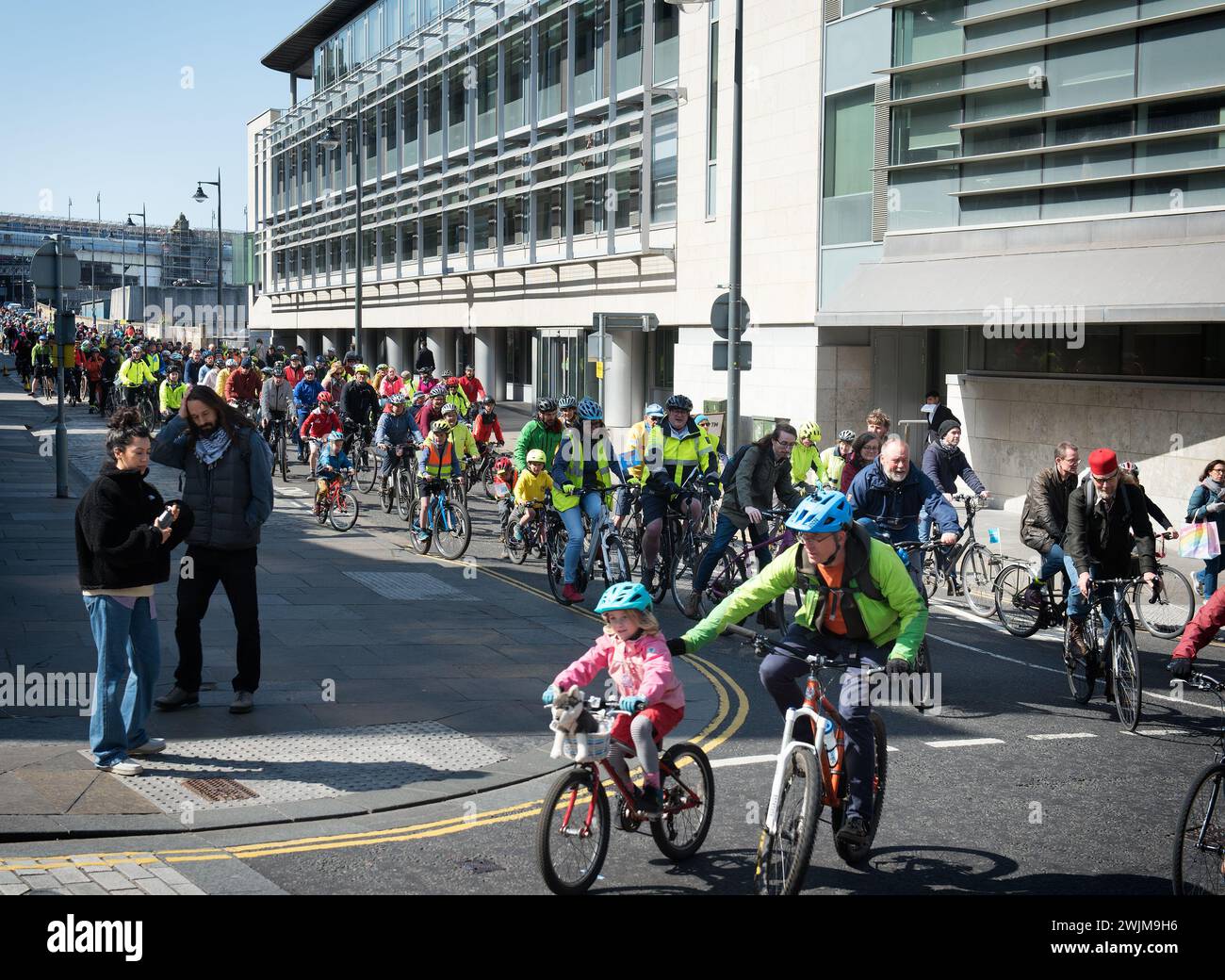 Hundreds of cyclists and people with bikes cycle through the streets of ...
