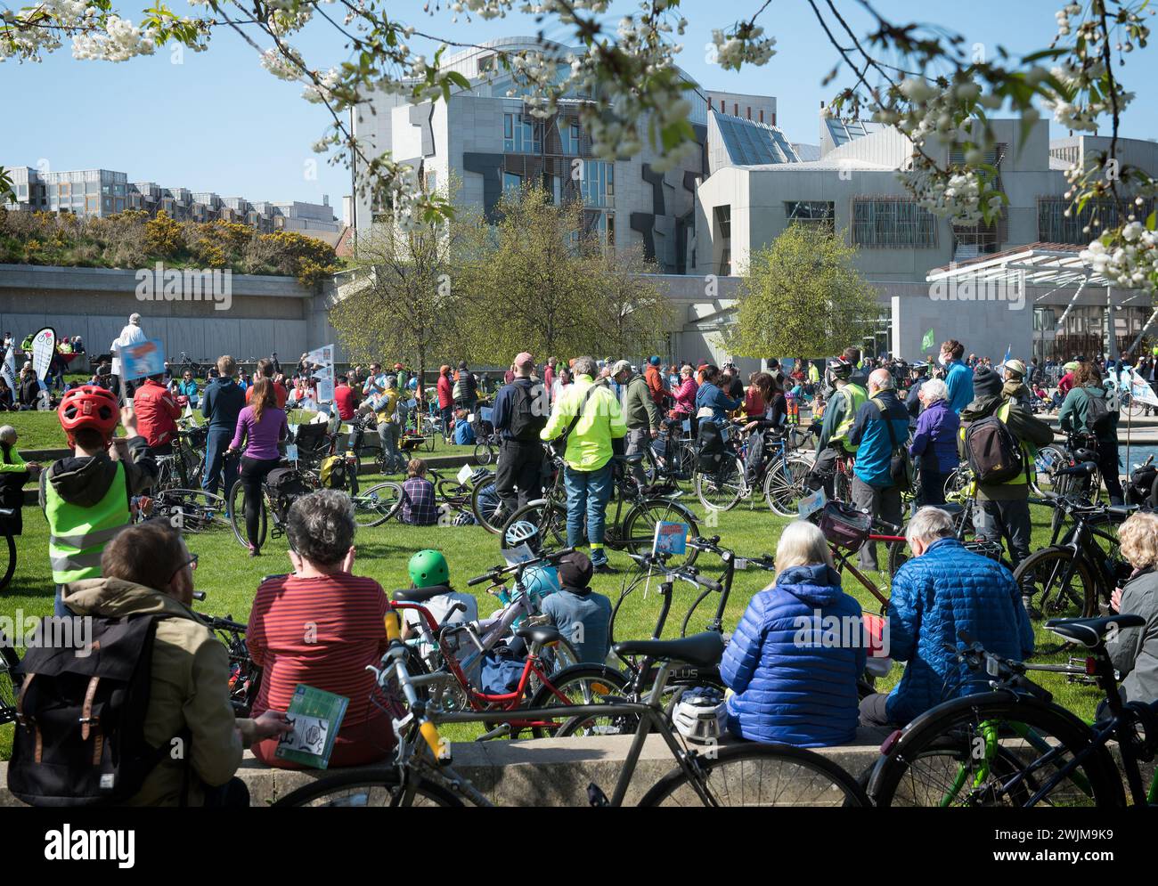 Hundreds of cyclists and people with bikes cycle through the streets of ...