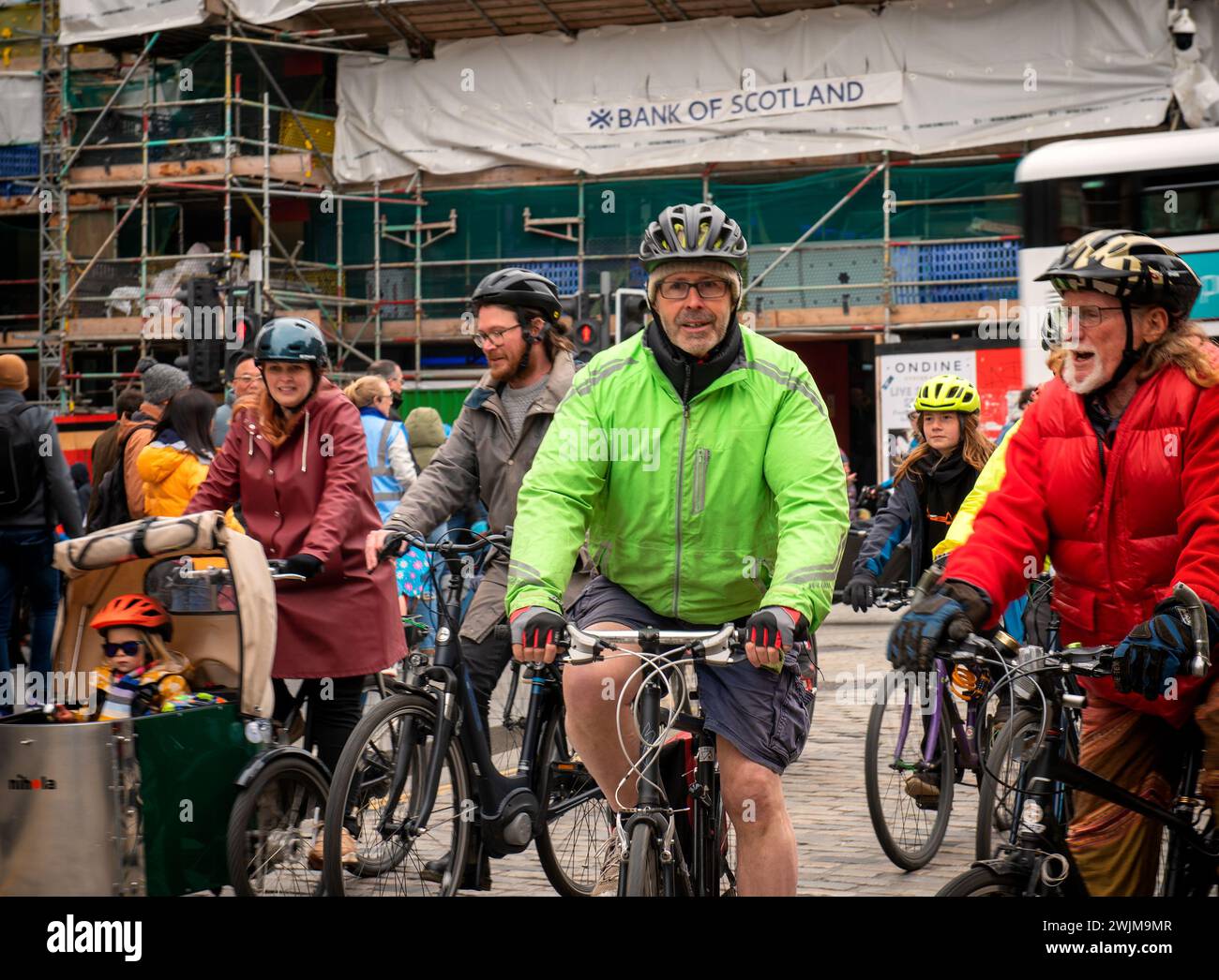Hundreds of cyclists and people with bikes cycle through the streets of ...