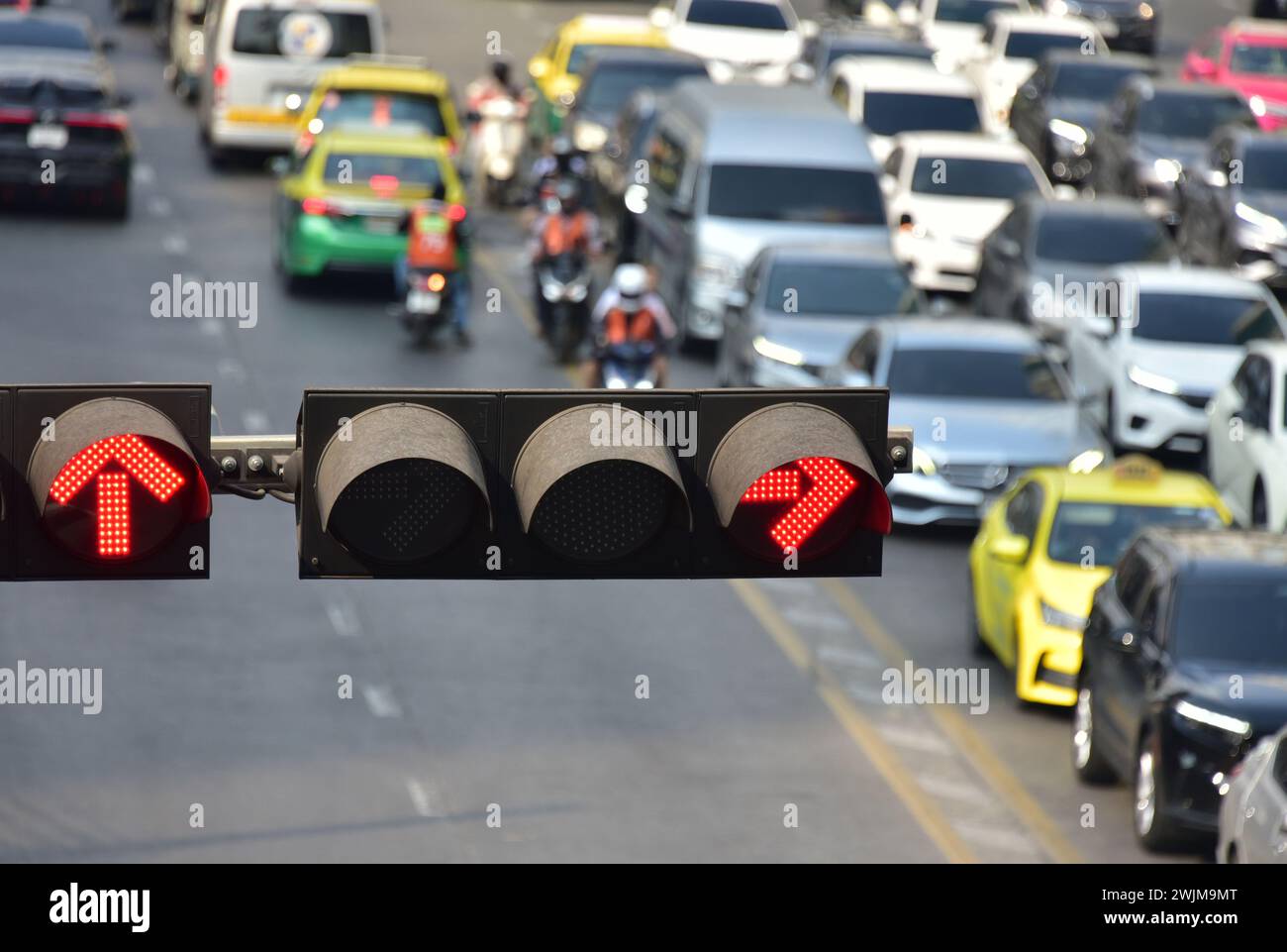Red traffic arrow signals with out of focus overhead view of a traffic ...