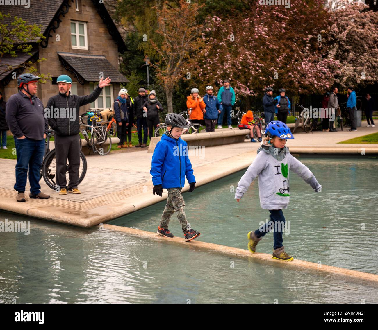 Children play in the water outside the Parliament at a protest to ...