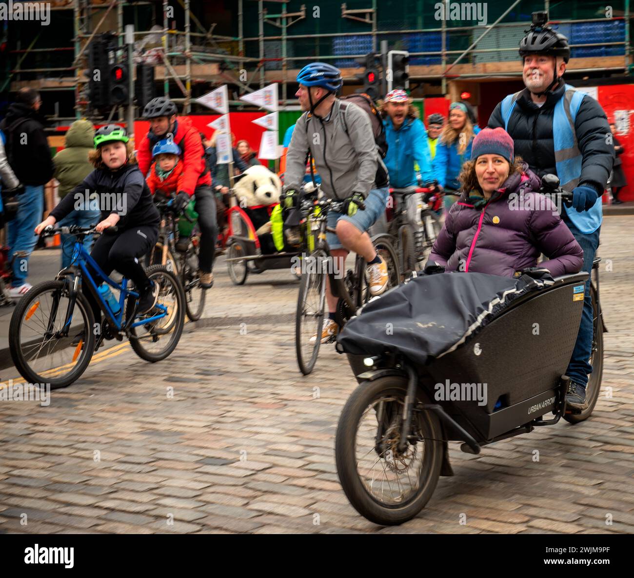 Hundreds of cyclists and people with bikes cycle through the streets of ...