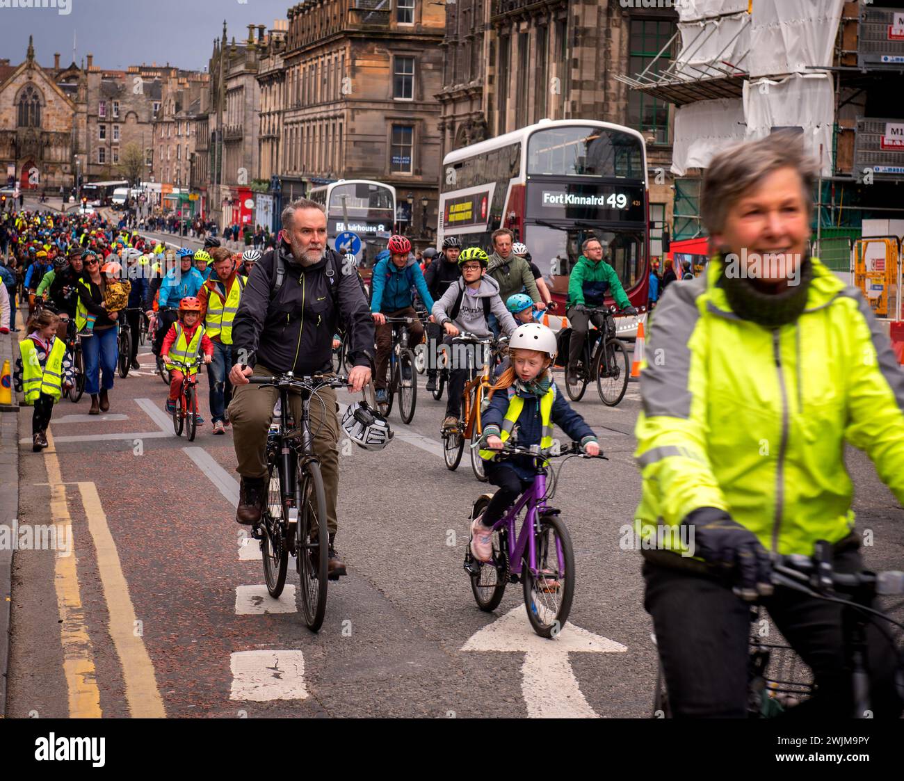 Hundreds of cyclists and people with bikes cycle through the streets of ...