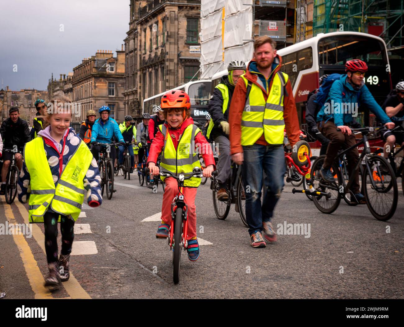 Hundreds of cyclists and people with bikes cycle through the streets of ...