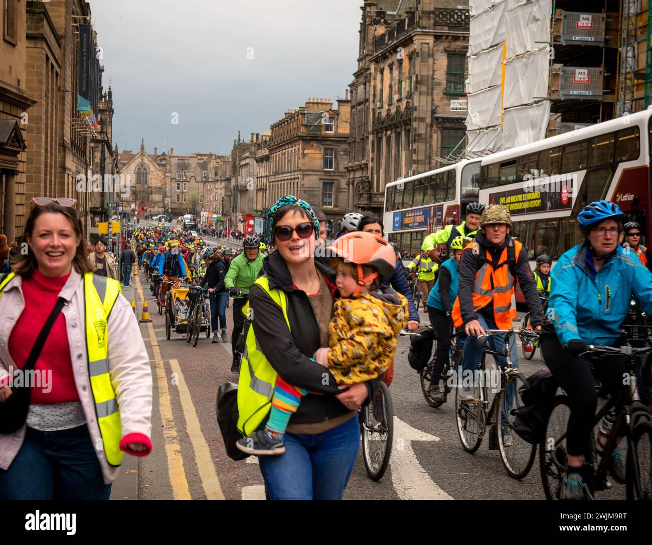 Hundreds of cyclists and people with bikes cycle through the streets of ...