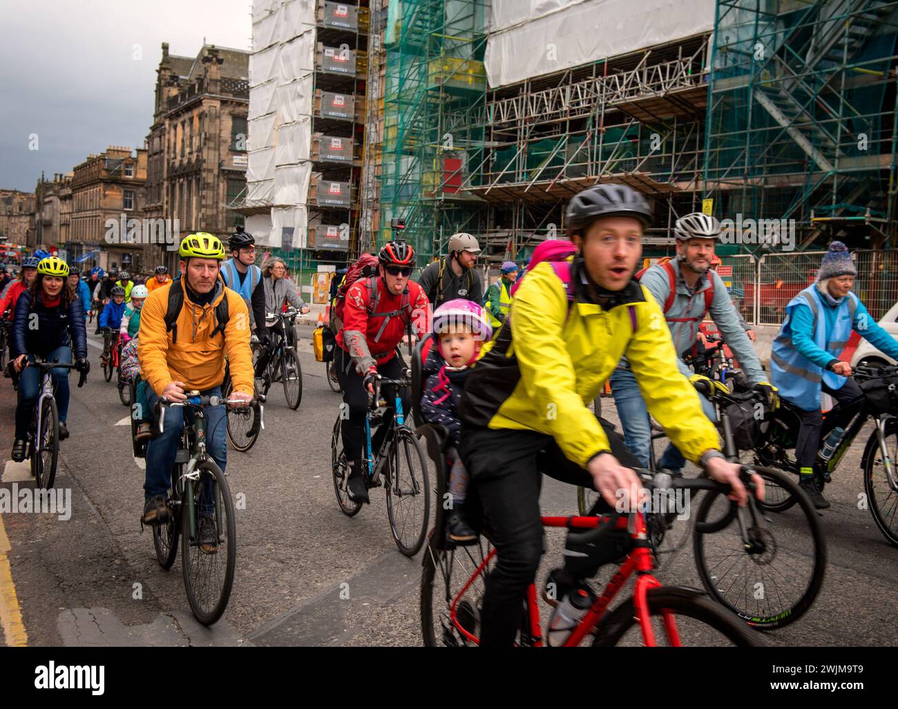 Hundreds of cyclists and people with bikes cycle through the streets of ...