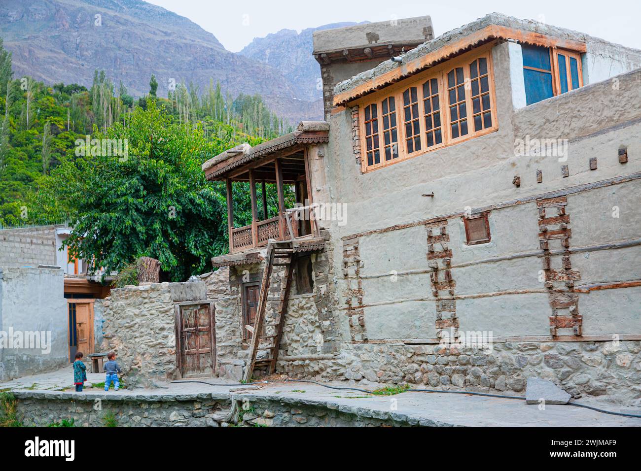 Children in the street and old buildings in Ganish village, Hunza ...