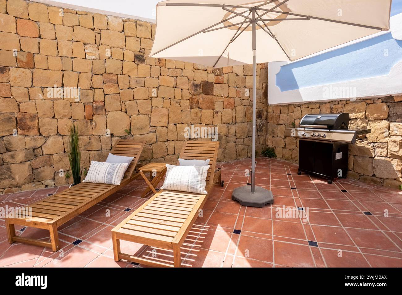 an image of wooden deck chairs and barbecue grill on a luxury ...