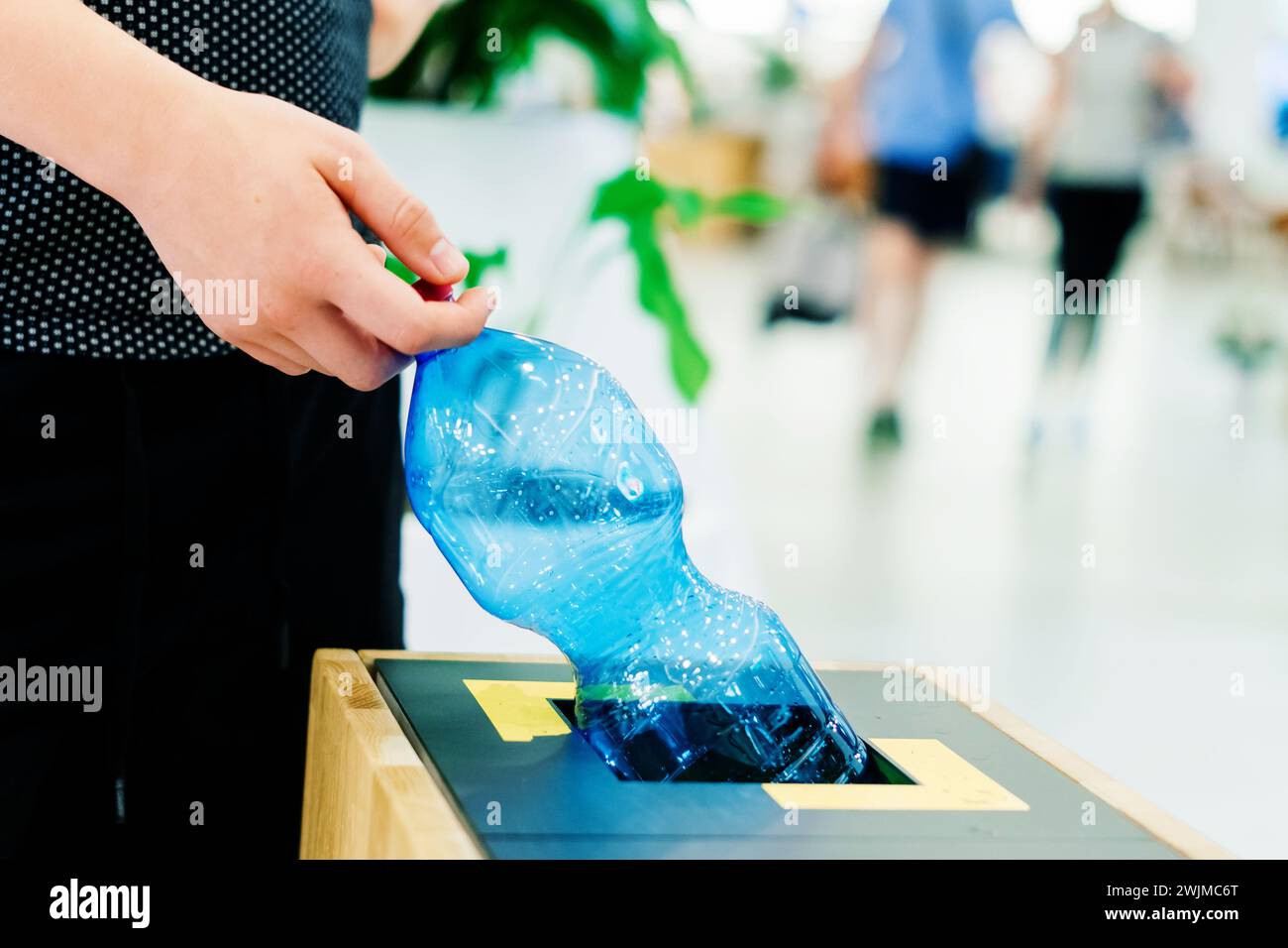 Close up hand throwing empty plastic water bottle into recycling bin, recycle rubbish Stock ...
