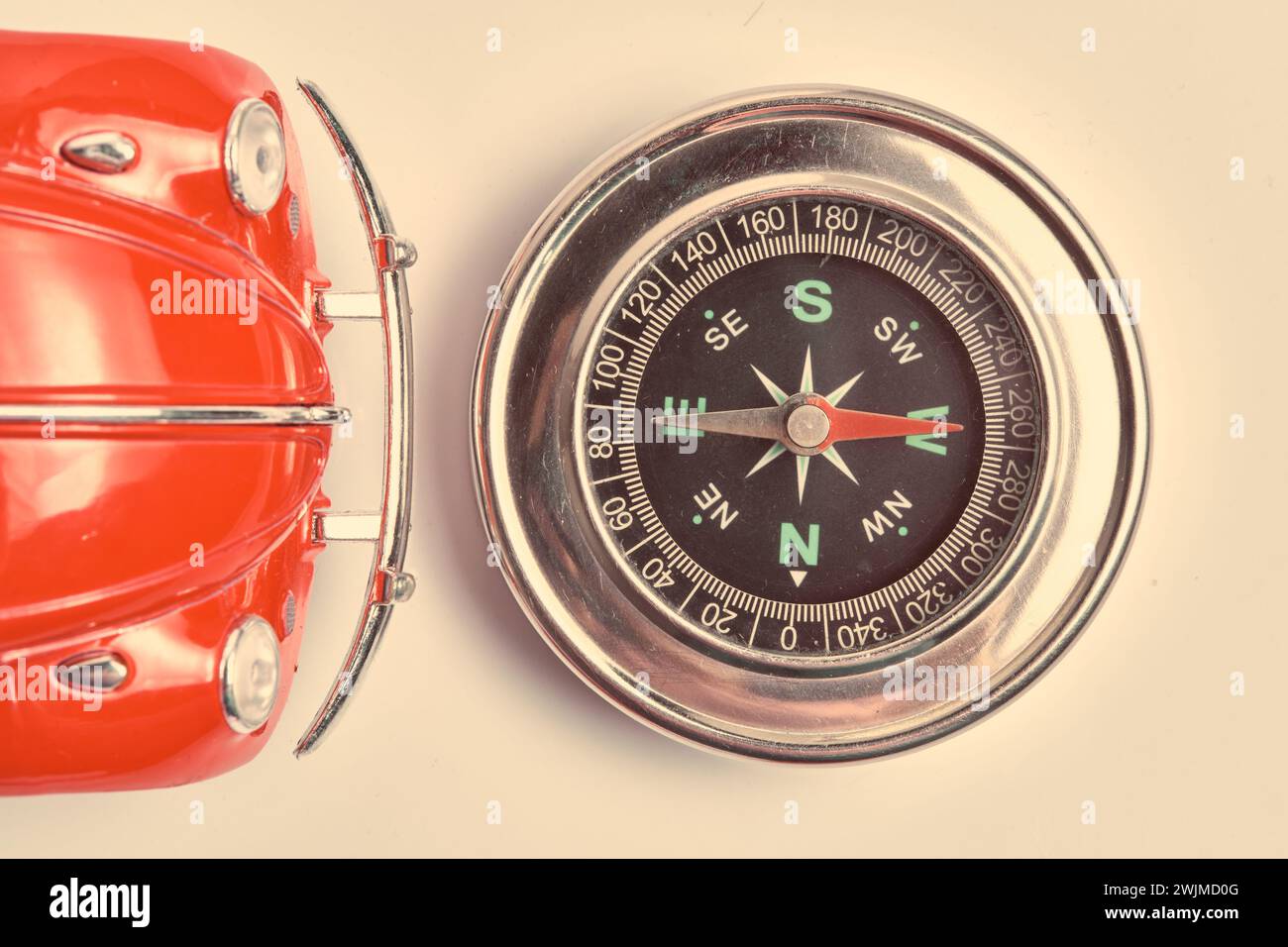 Hood red car and compass pointing west. Concept traveling by car Stock ...