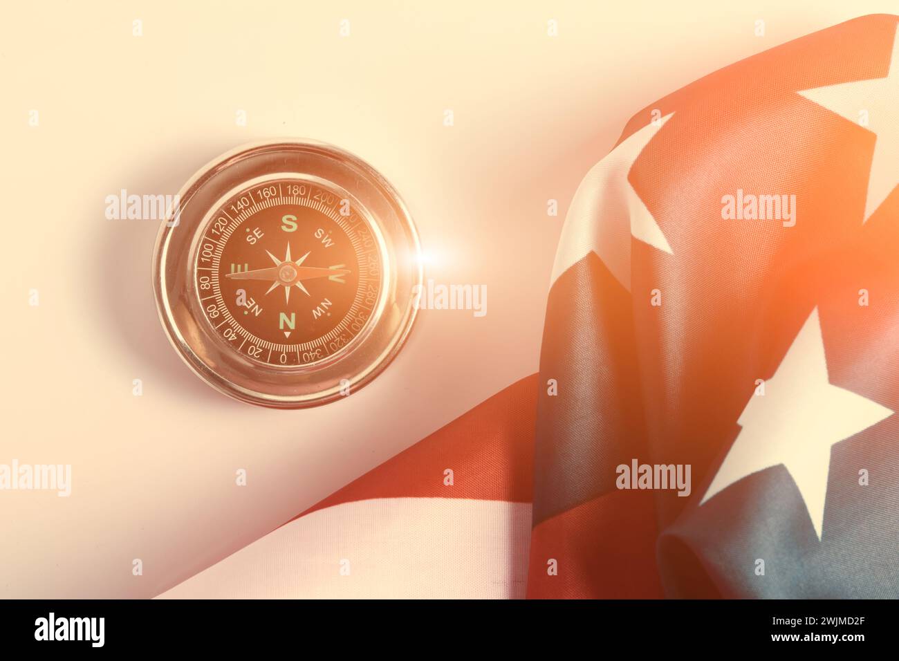 Compass pointing west and star spangled flag United States America ...