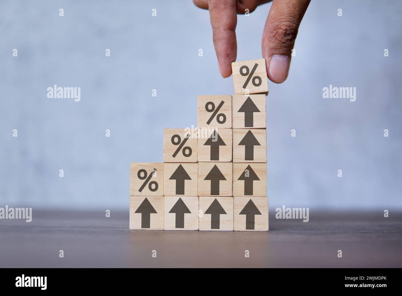 Interest rate, growth and business concept. Hand putting wooden cube ...