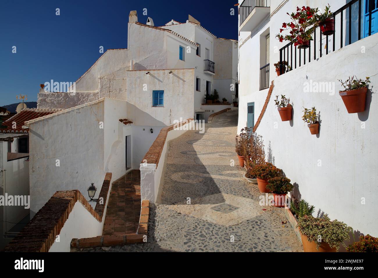 Picturesque narrow and steep cobbled alleys in Frigiliana, Axarquia ...