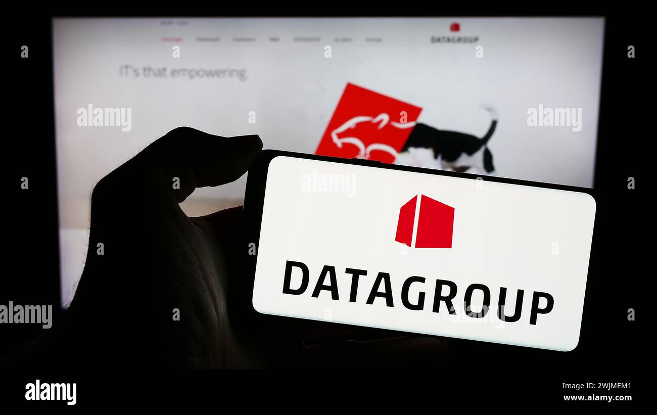 Person holding cellphone with logo of German information technology ...