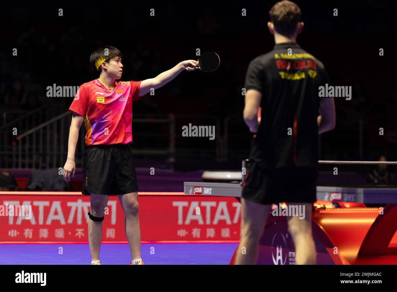 Busan, South Korea. 16th Feb, 2024. Wang Chuqin (L) of China reacts while competing against ...