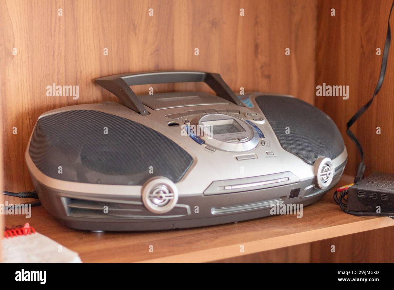 Shot of an old fashioned CD, radio and cassette player covered in dust ...