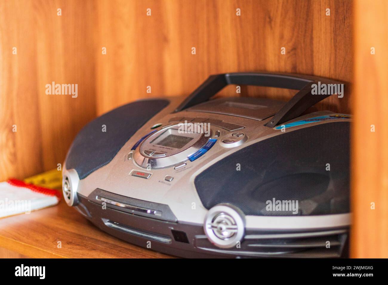 Shot of an old fashioned CD, radio and cassette player covered in dust ...