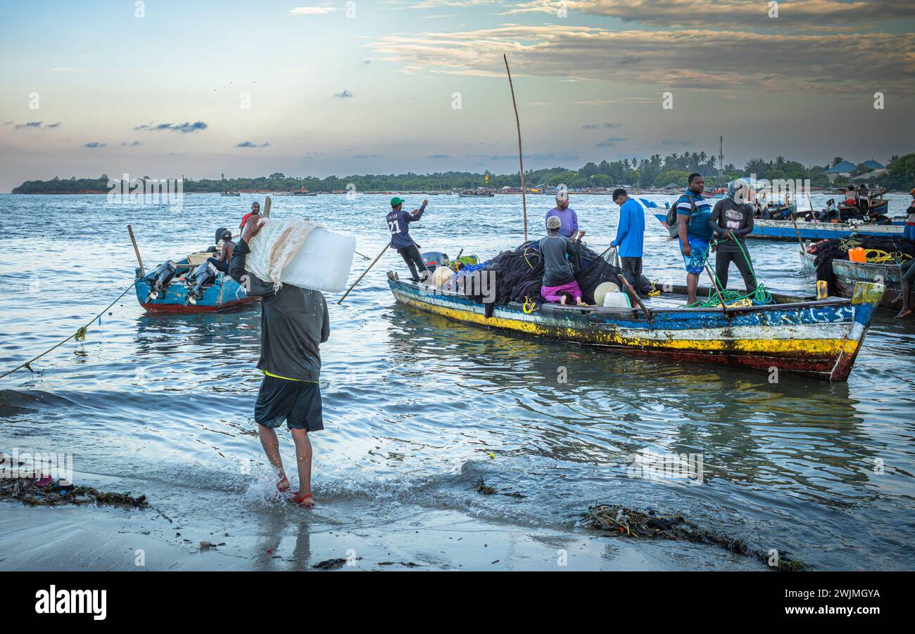 A porter carries a block of ice in the evening to a traditional wooden ...