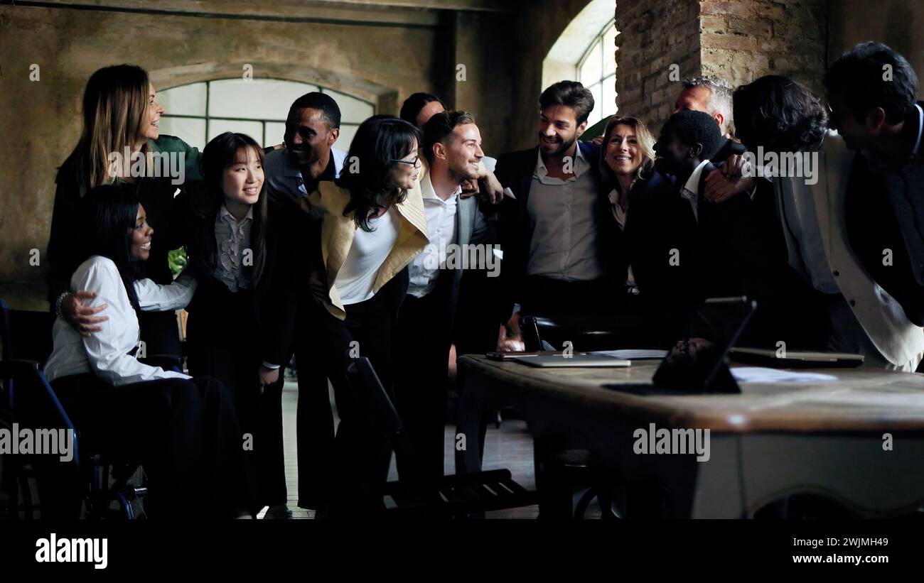 Multiracial business group of people celebrating and hugging together ...