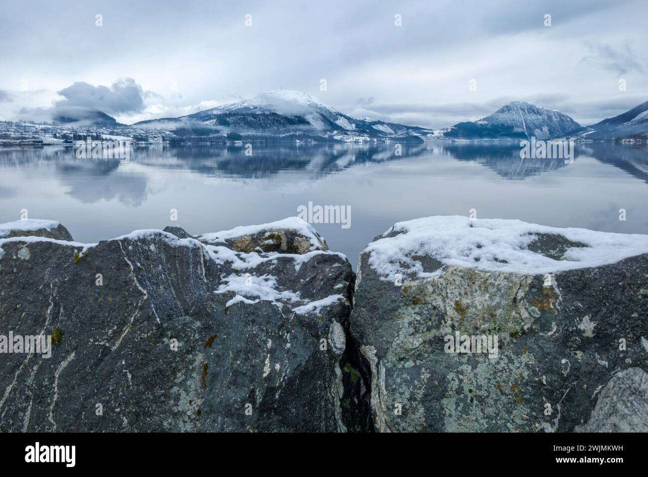 A serene winter landscape captures the stillness of a snow-blanketed ...