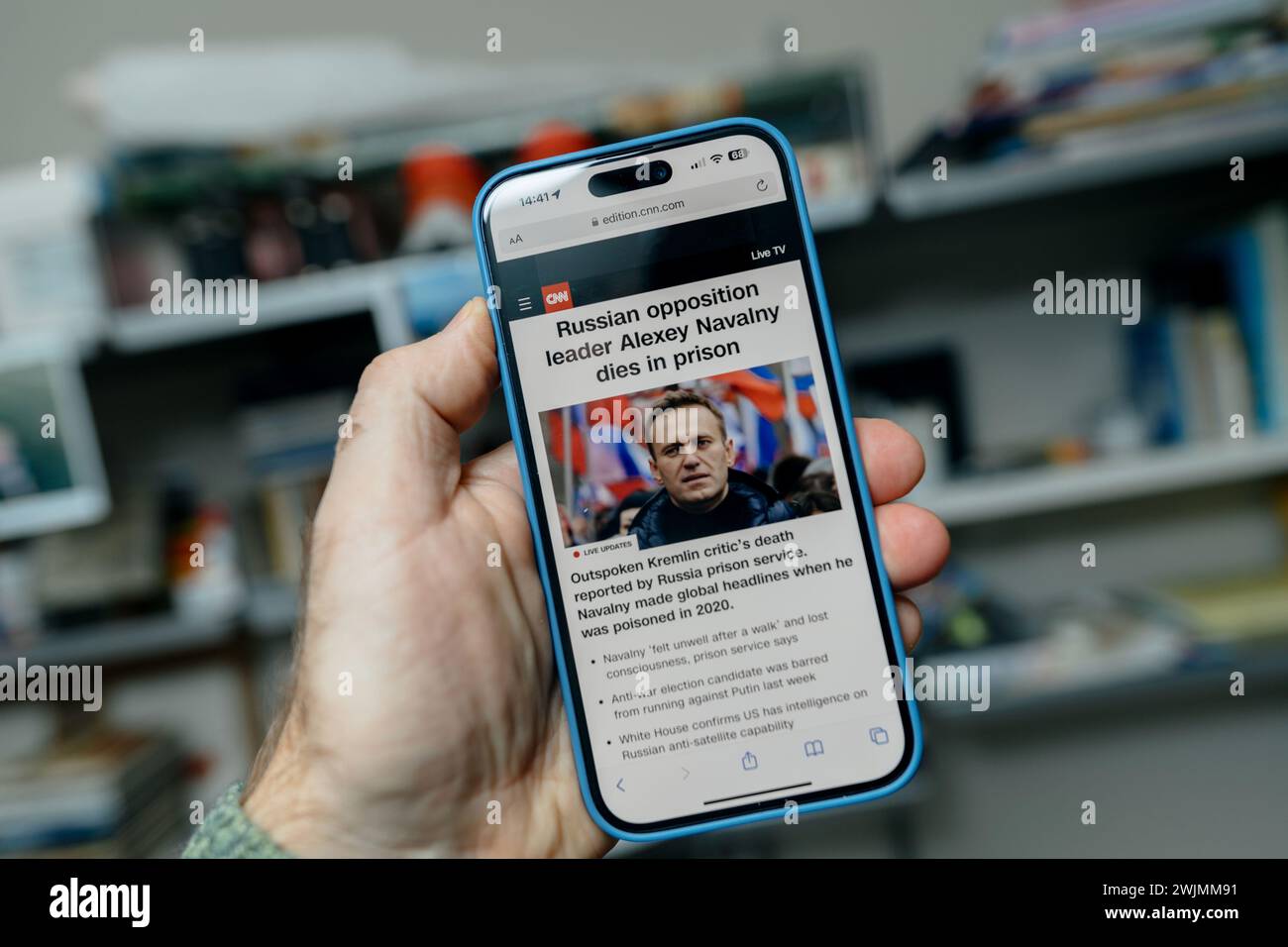 Paris, France - Feb 16, 2024: POV male hand reading headlines on his ...