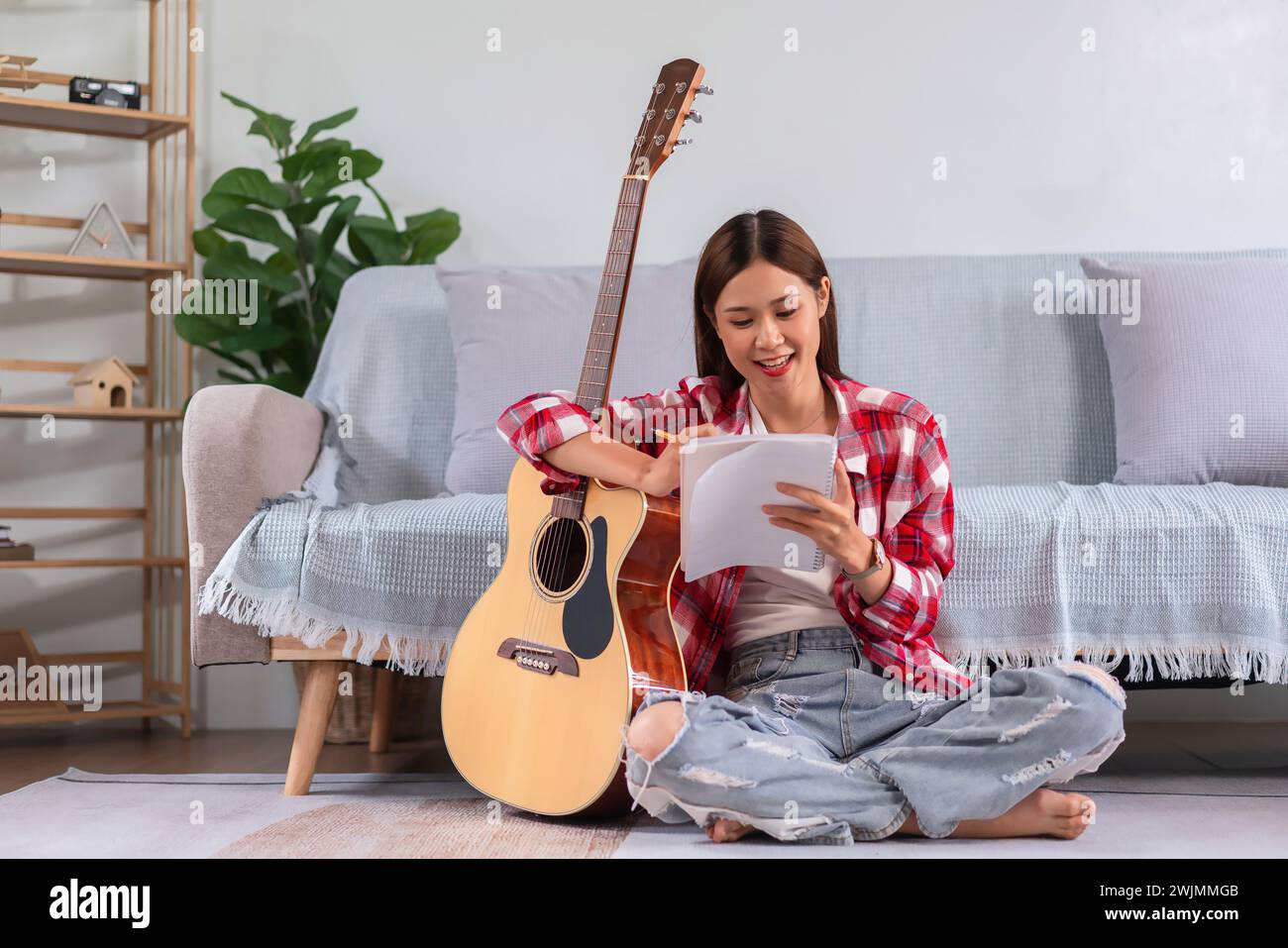 Concept of relaxation with music, Young woman is composing new song and ...