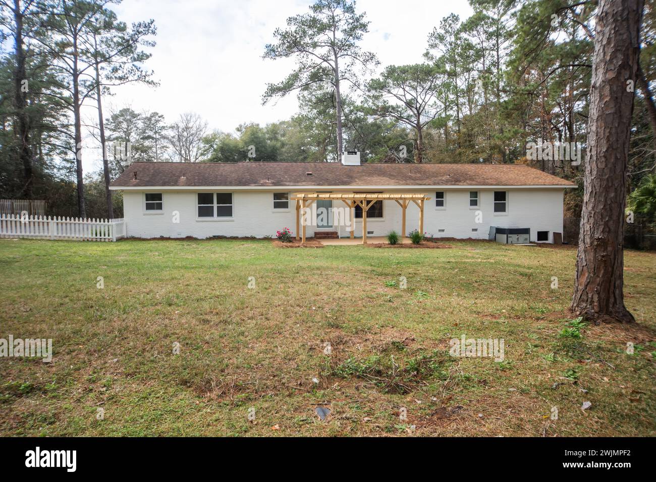 The rear back exterior of a newly painted and renovated white brick ...