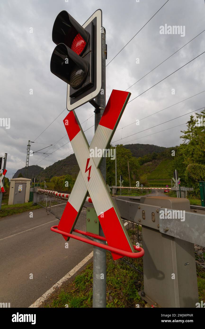 Red and white traffic sign for railroad crossing with a red stoplight ...