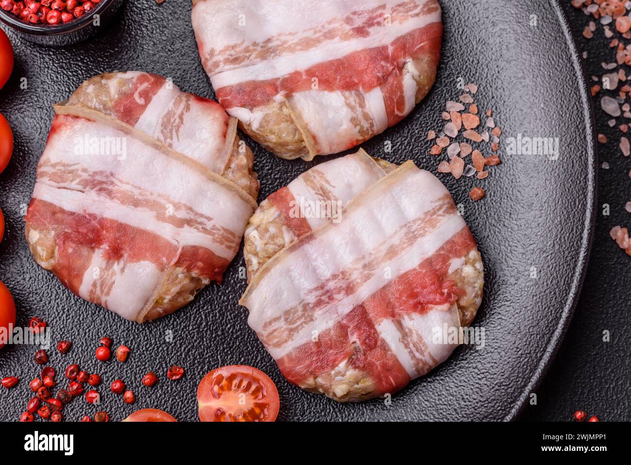 Round minced chicken or pork cutlet wrapped in bacon with salt, spices ...