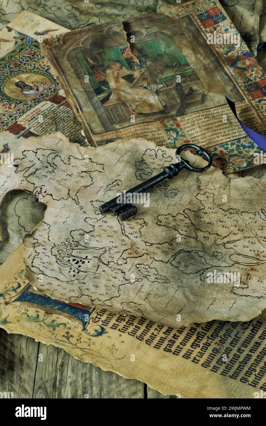 An old style key laying on old hand drawn maps and old manuscripts ...
