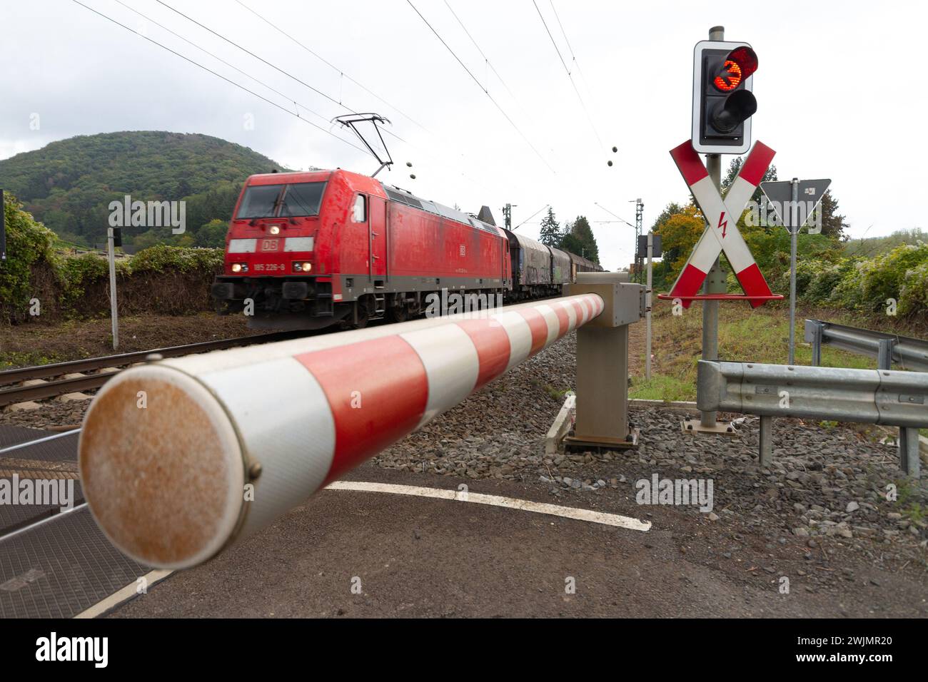 a red warning sign with a freight train in background Stock Photo - Alamy