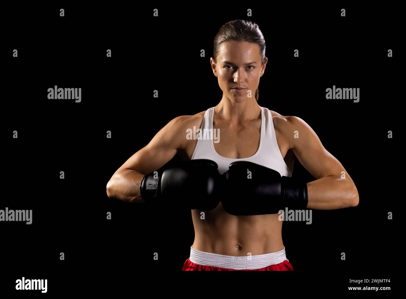 Young Caucasian woman poses confidently in boxing gear, with copy space ...