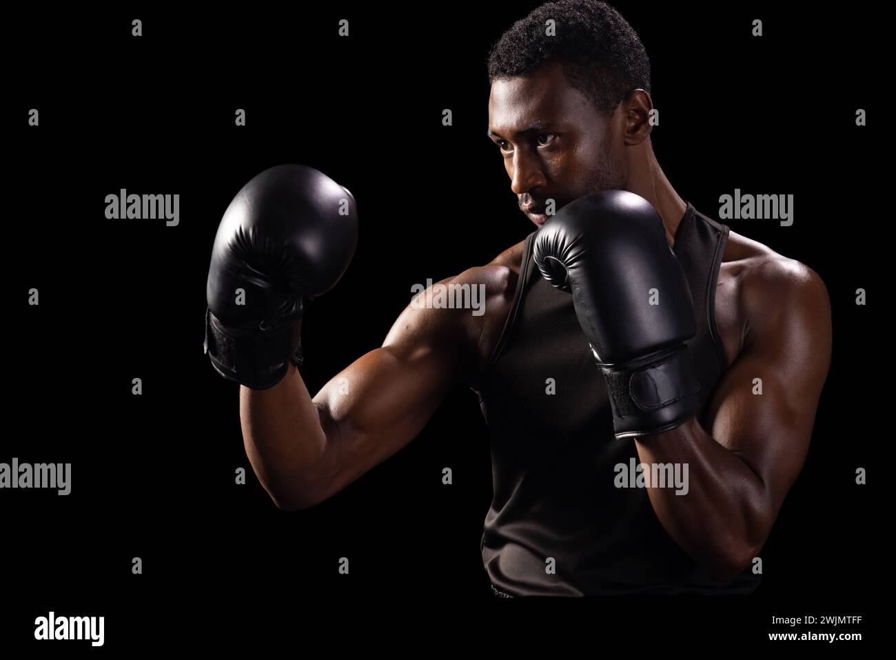 African American man in a boxing stance, with copy space. His intense ...