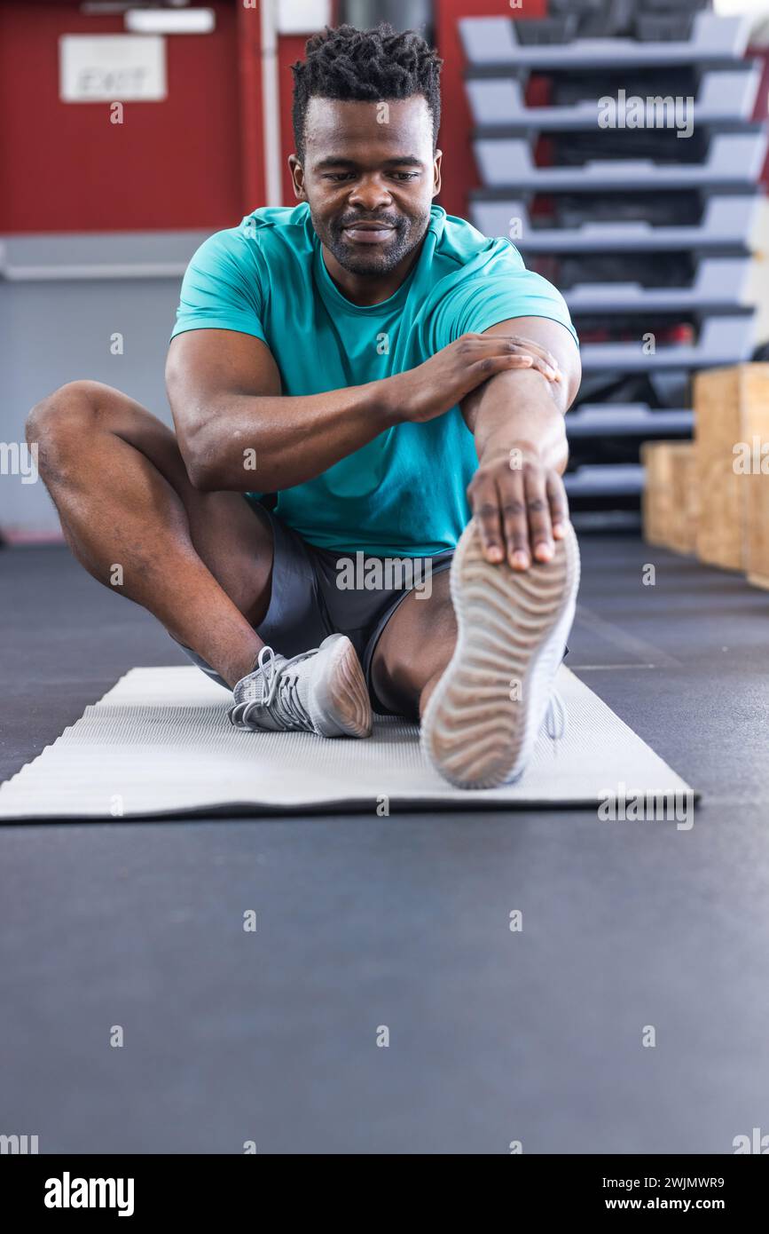 Fit African American man stretching at the gym Stock Photo - Alamy