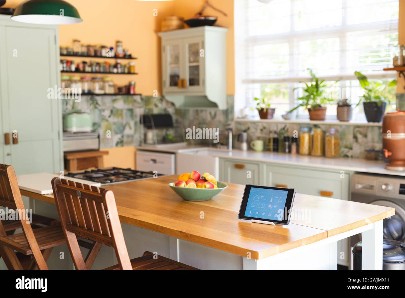 A modern kitchen interior features a smart home tablet Stock Photo - Alamy